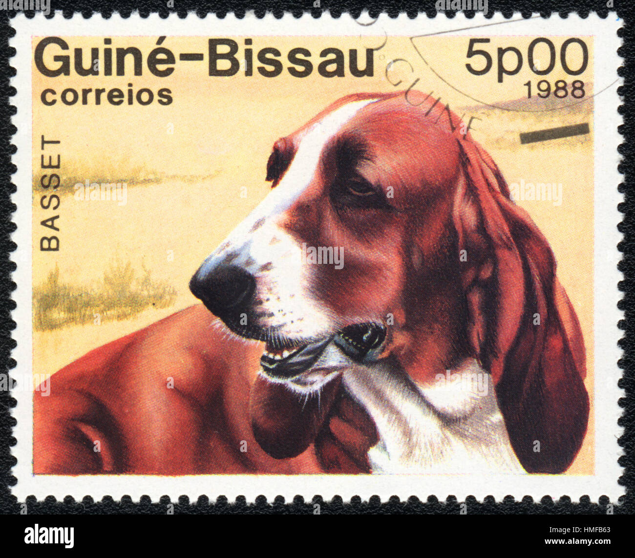 A postage stamp printed in Guinea-Bissau shows a dog Basset, from ...