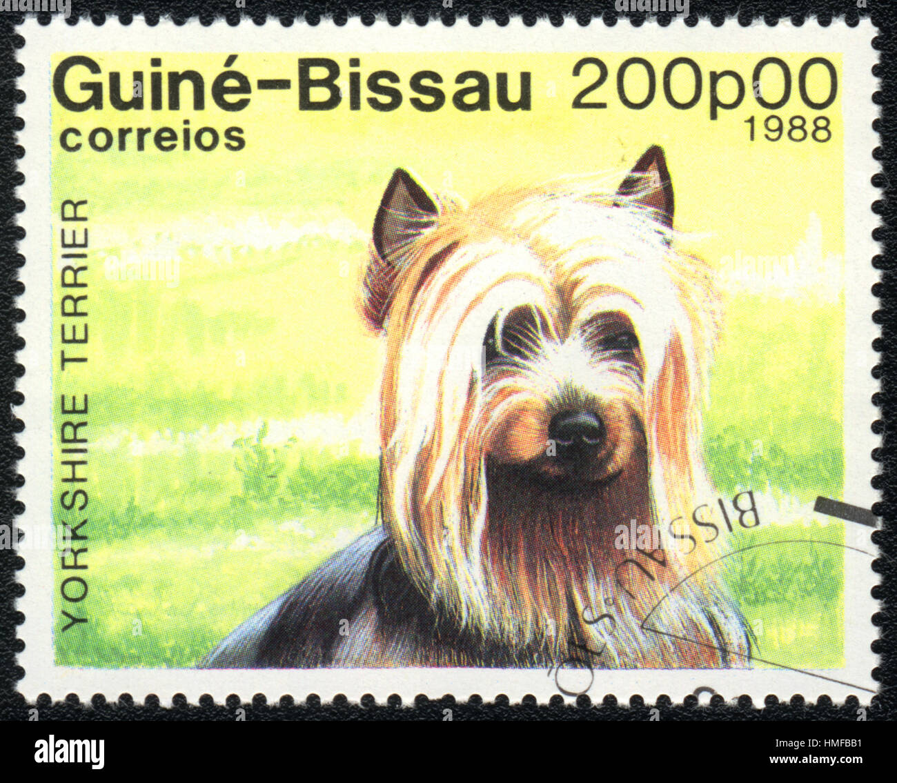 A postage stamp printed in Guinea-Bissau shows a dog Yorkshire terrier ...