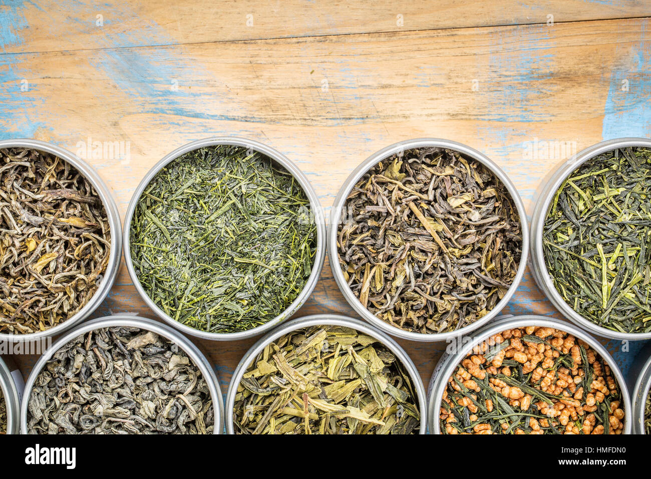 green tea sampler - top view of loose leaf teas in tins against grunge ...