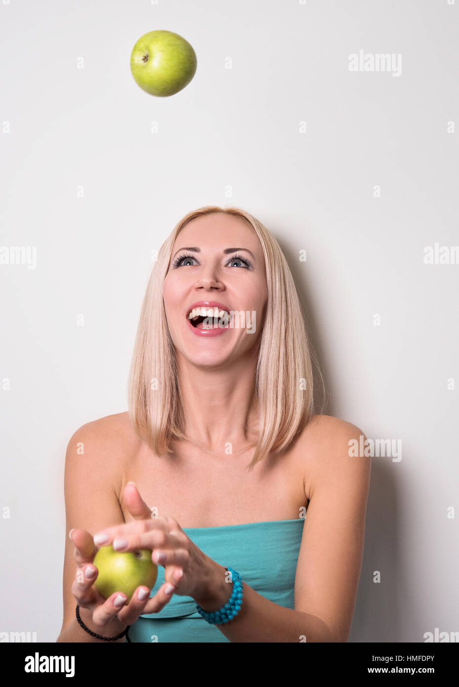 girl throws green Apple Stock Photo - Alamy