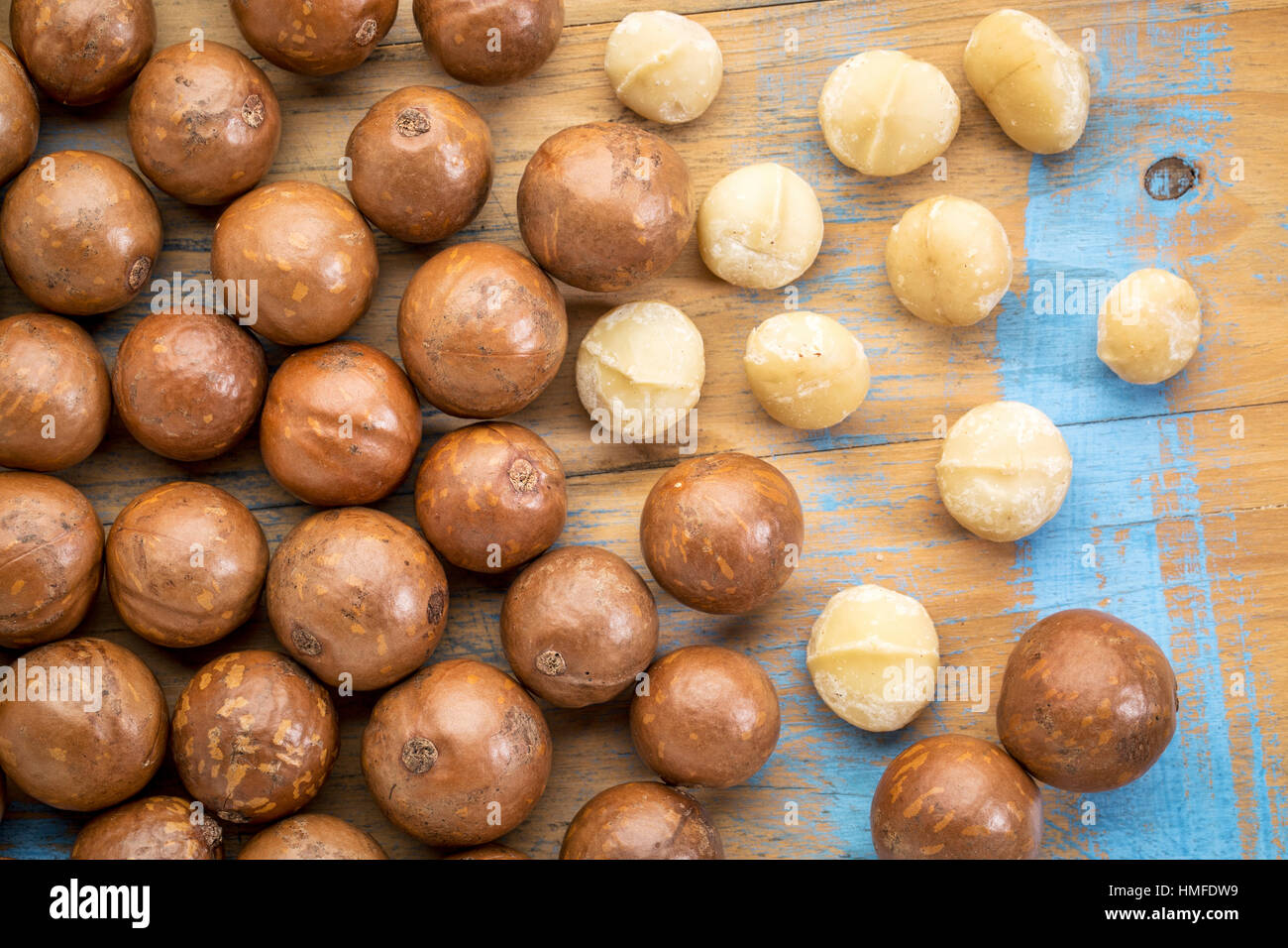 macadamia nuts in shells and without on a rustic grunge wood - top view ...