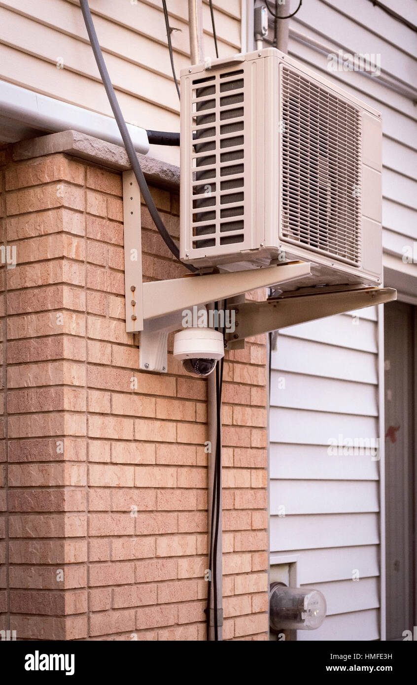 Residential surveillance camera installed under split compressor unit ...