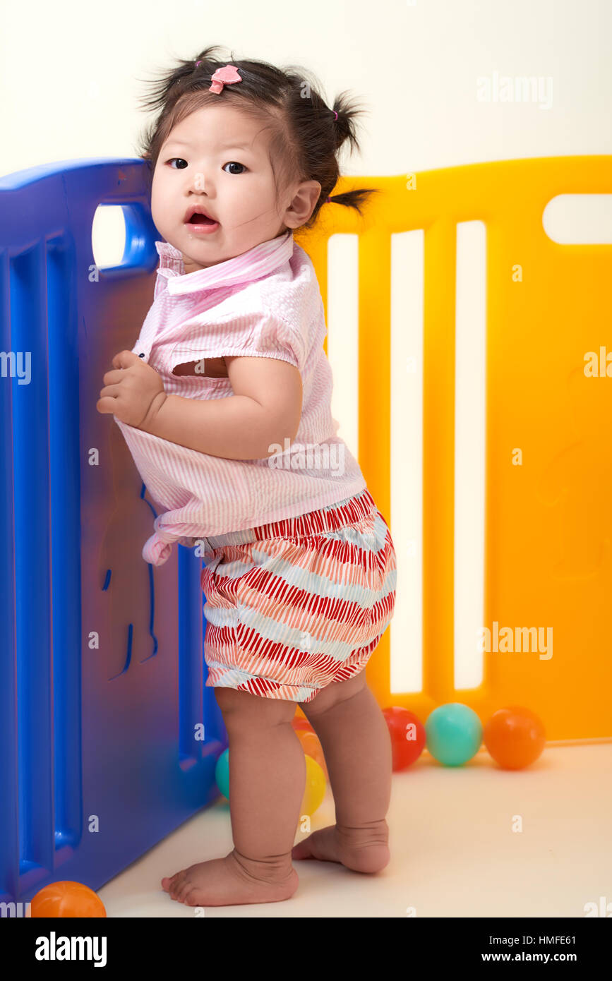 Asian Chinese baby girl playing with colorful balls fenced Stock Photo ...