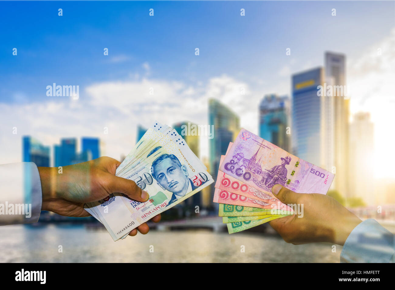 Business man hand Exchange Money Singapore Dollar and Thai Baht, Double ...