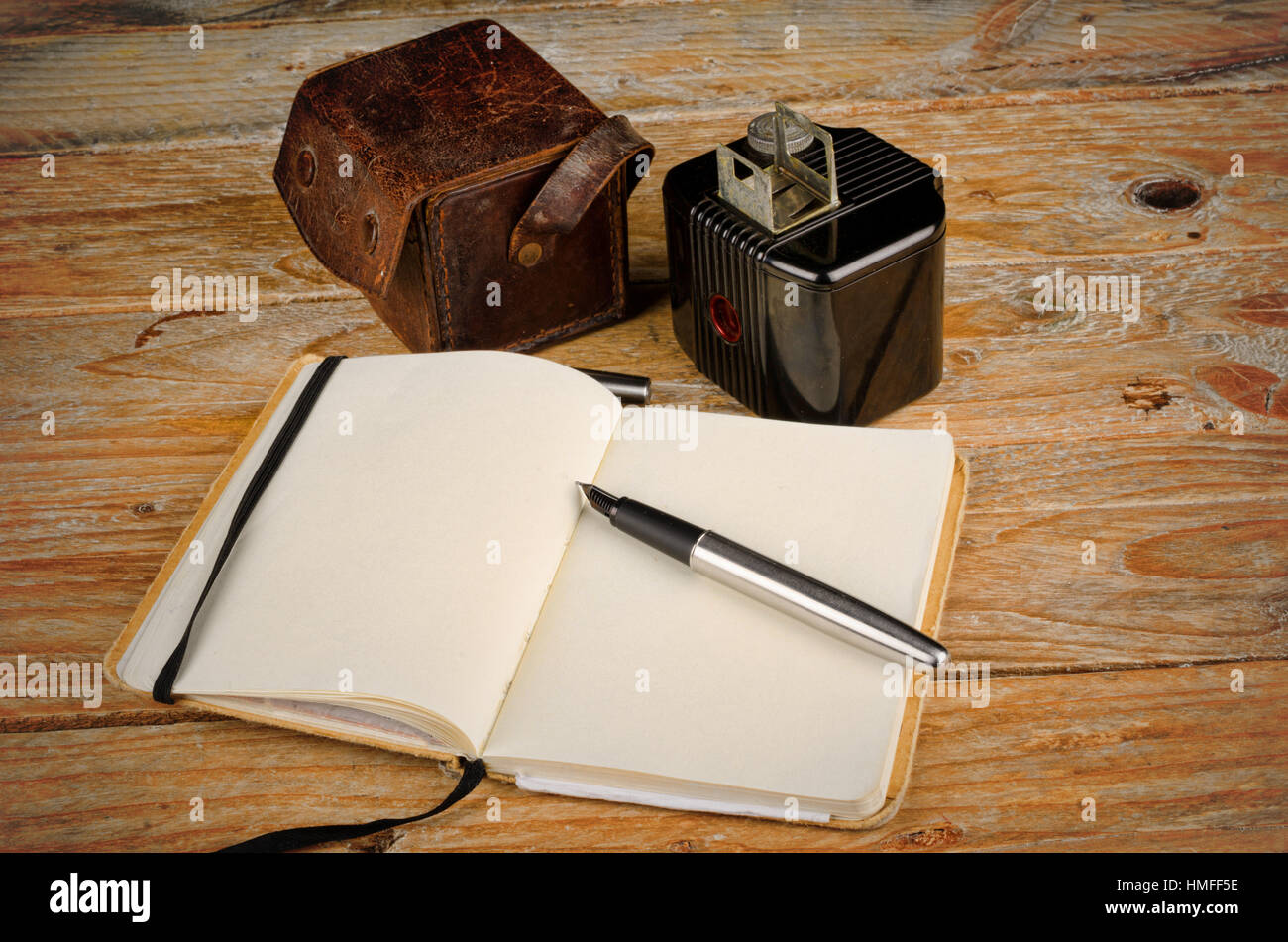 Still life with vintage camera, fountain pen and notebook, a journalism ...