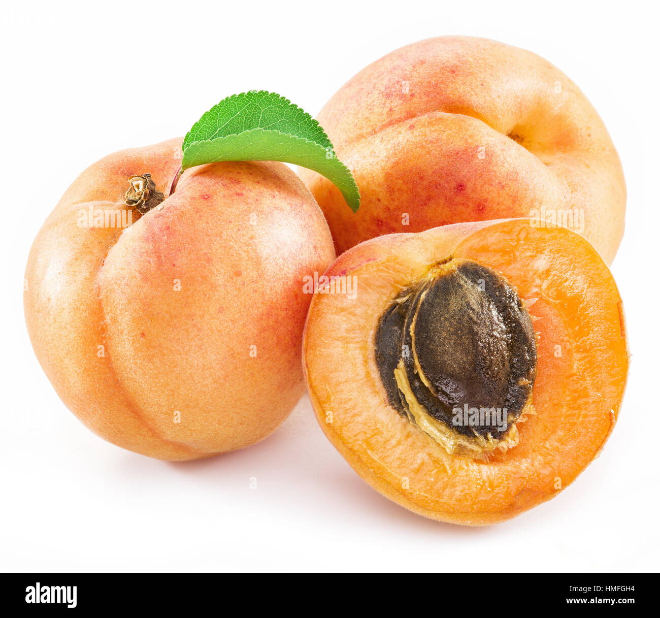 Apricots and its cross-section on the white background Stock Photo - Alamy
