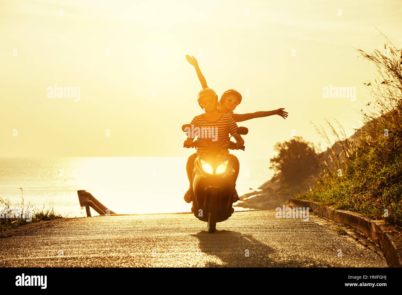 Happy couple travel motorcycle sea road Stock Photo - Alamy