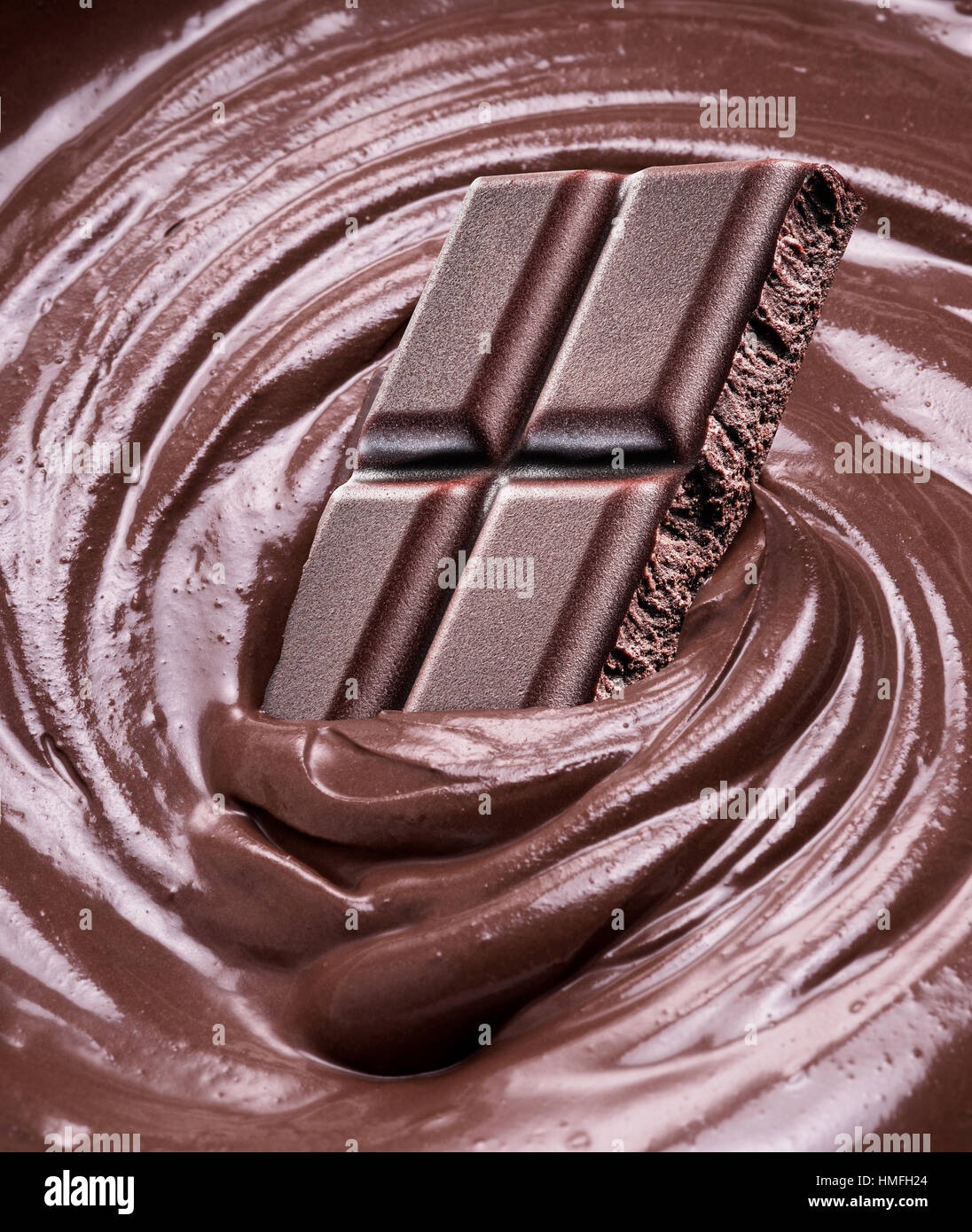 Melted chocolate and bar of chocolate dipped in it Stock Photo - Alamy