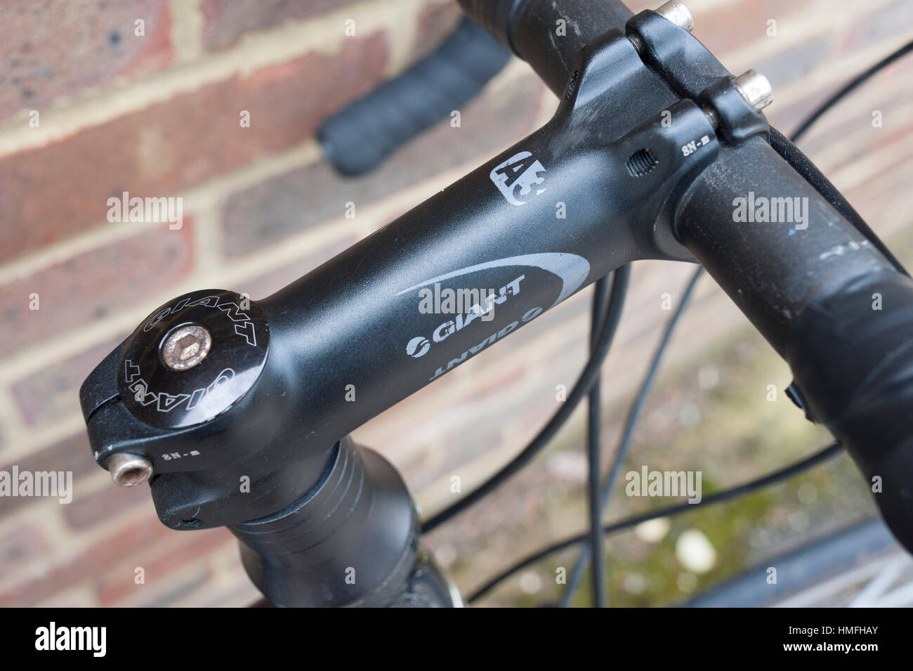 details of an old black giant road bike / bicycle up against a wall ...