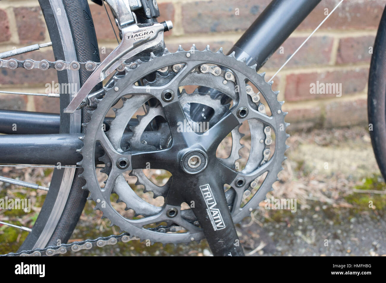 details of an old black giant road bike / bicycle up against a wall ...