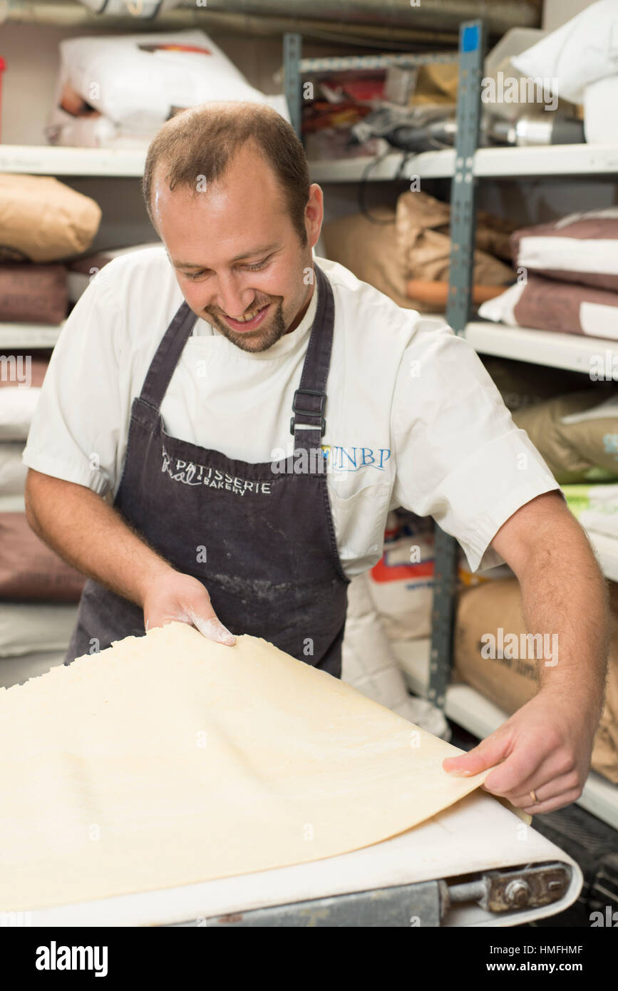 a professional chef prepares and cooks loafs of bread and baking ...