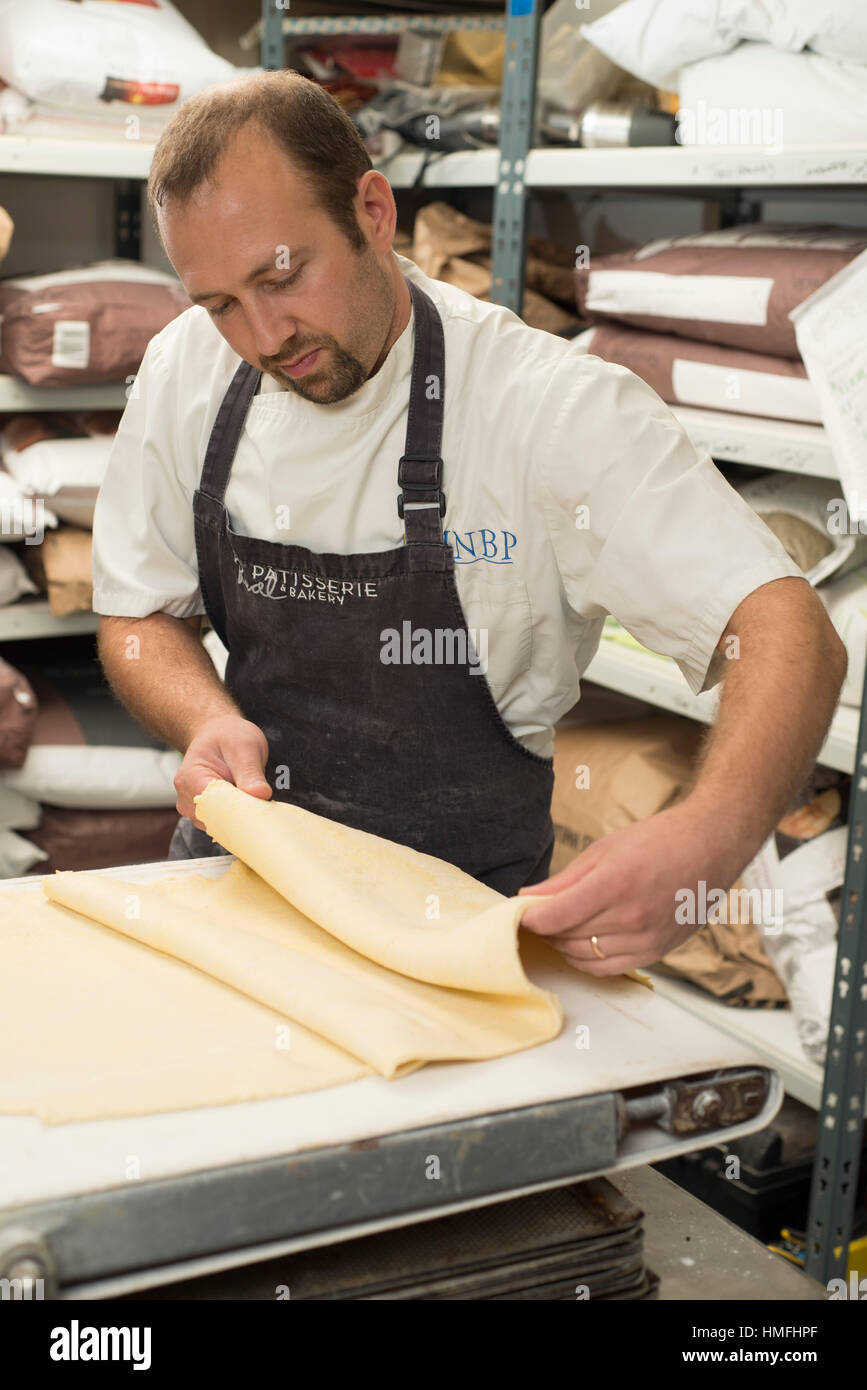 a professional chef prepares and cooks loafs of bread and baking ...