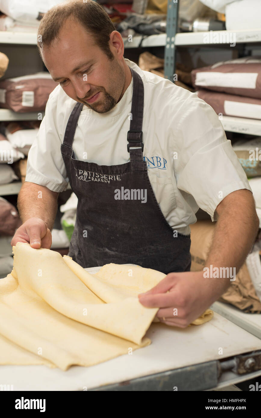 a professional chef prepares and cooks loafs of bread and baking ...
