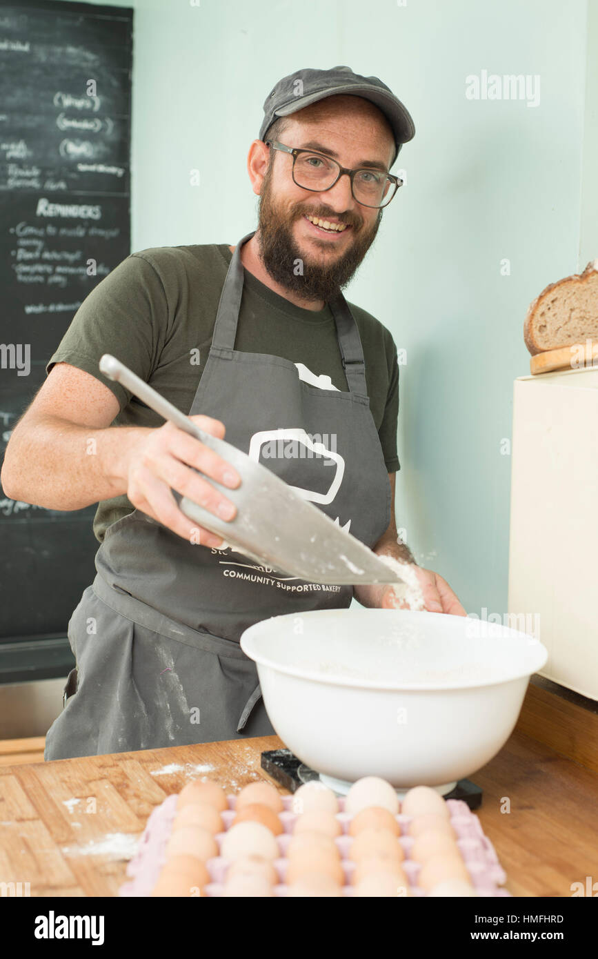 a professional chef prepares and cooks loafs of bread and baking ...