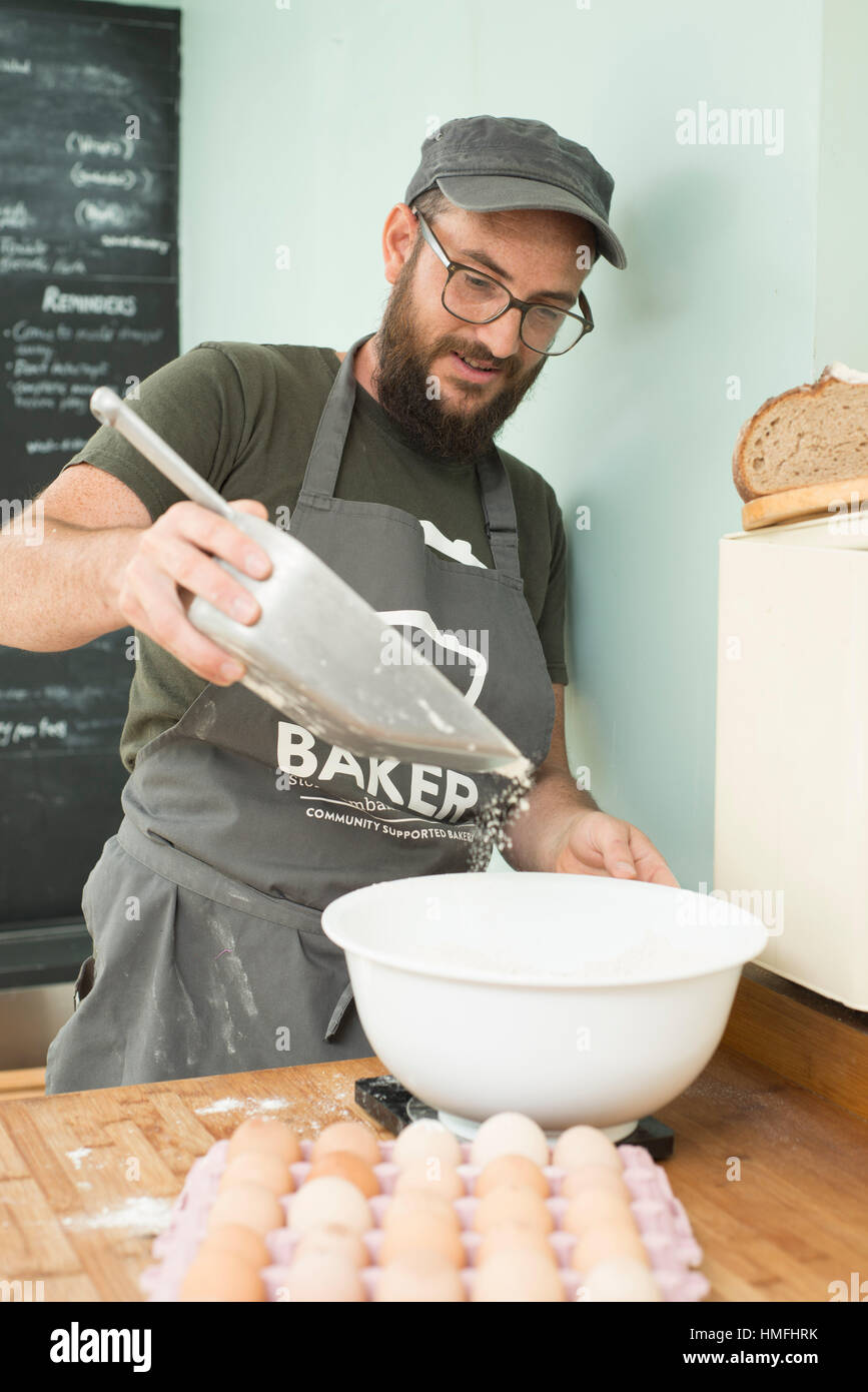 a professional chef prepares and cooks loafs of bread and baking ...