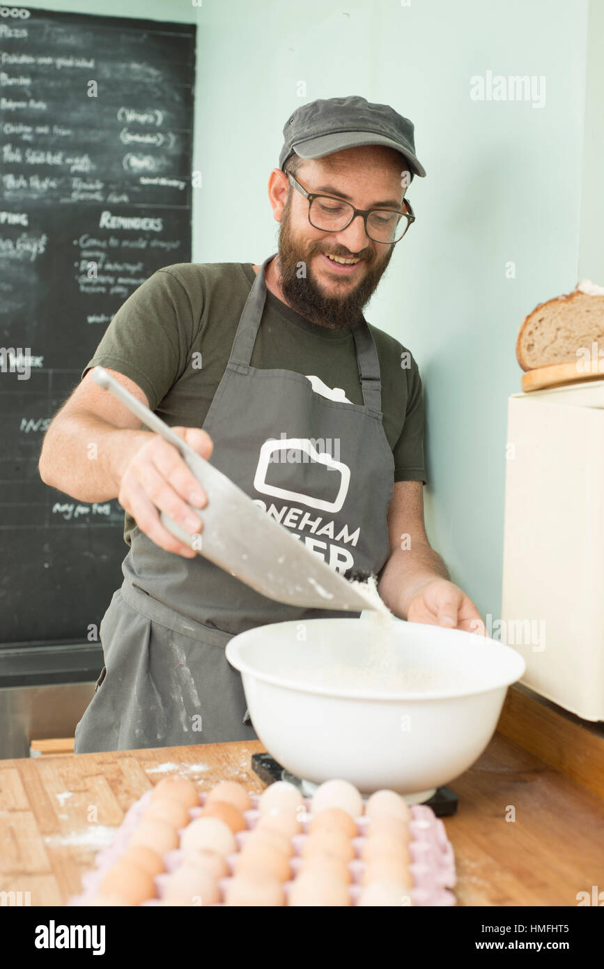 a professional chef prepares and cooks loafs of bread and baking ...