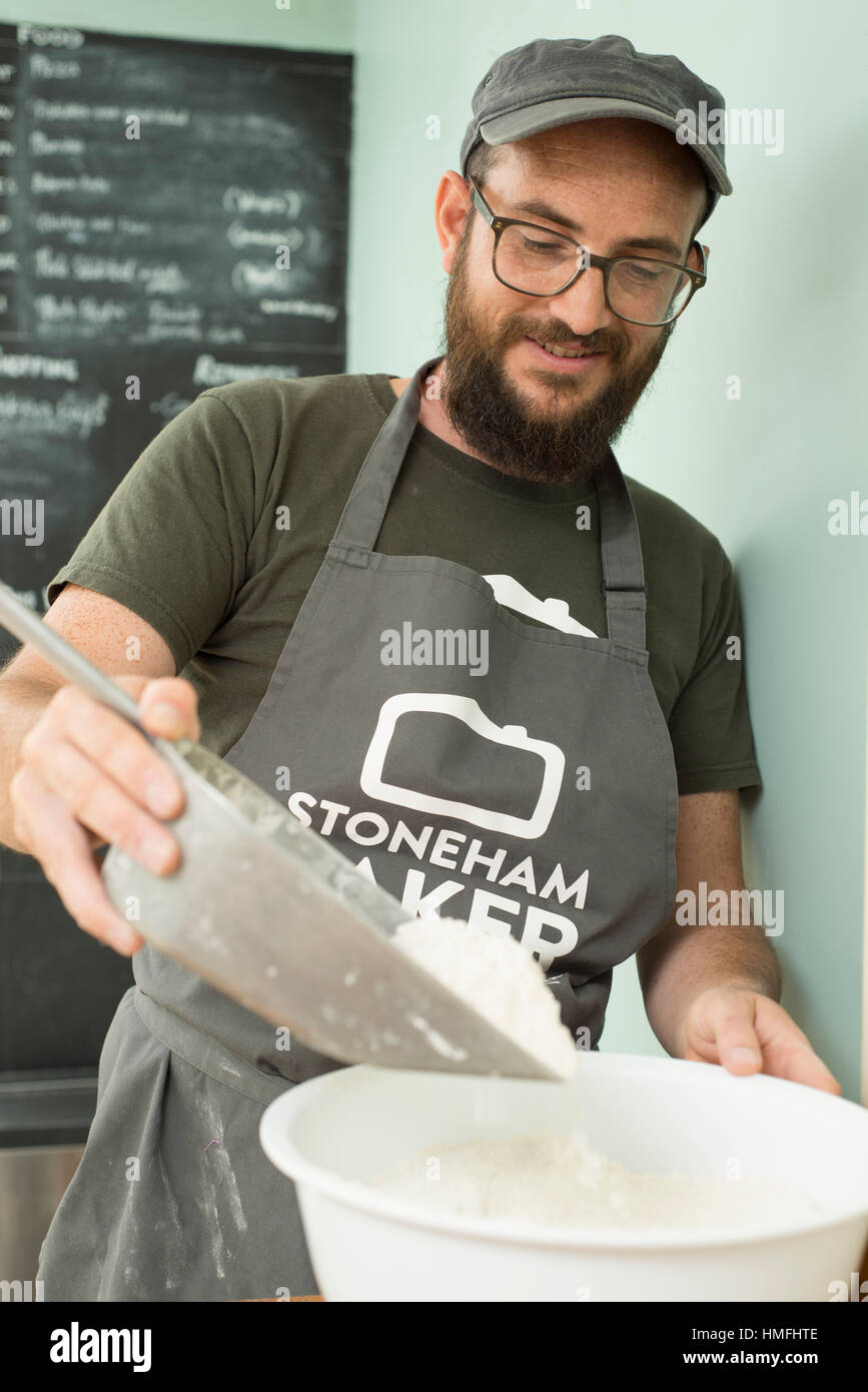 a professional chef prepares and cooks loafs of bread and baking ...