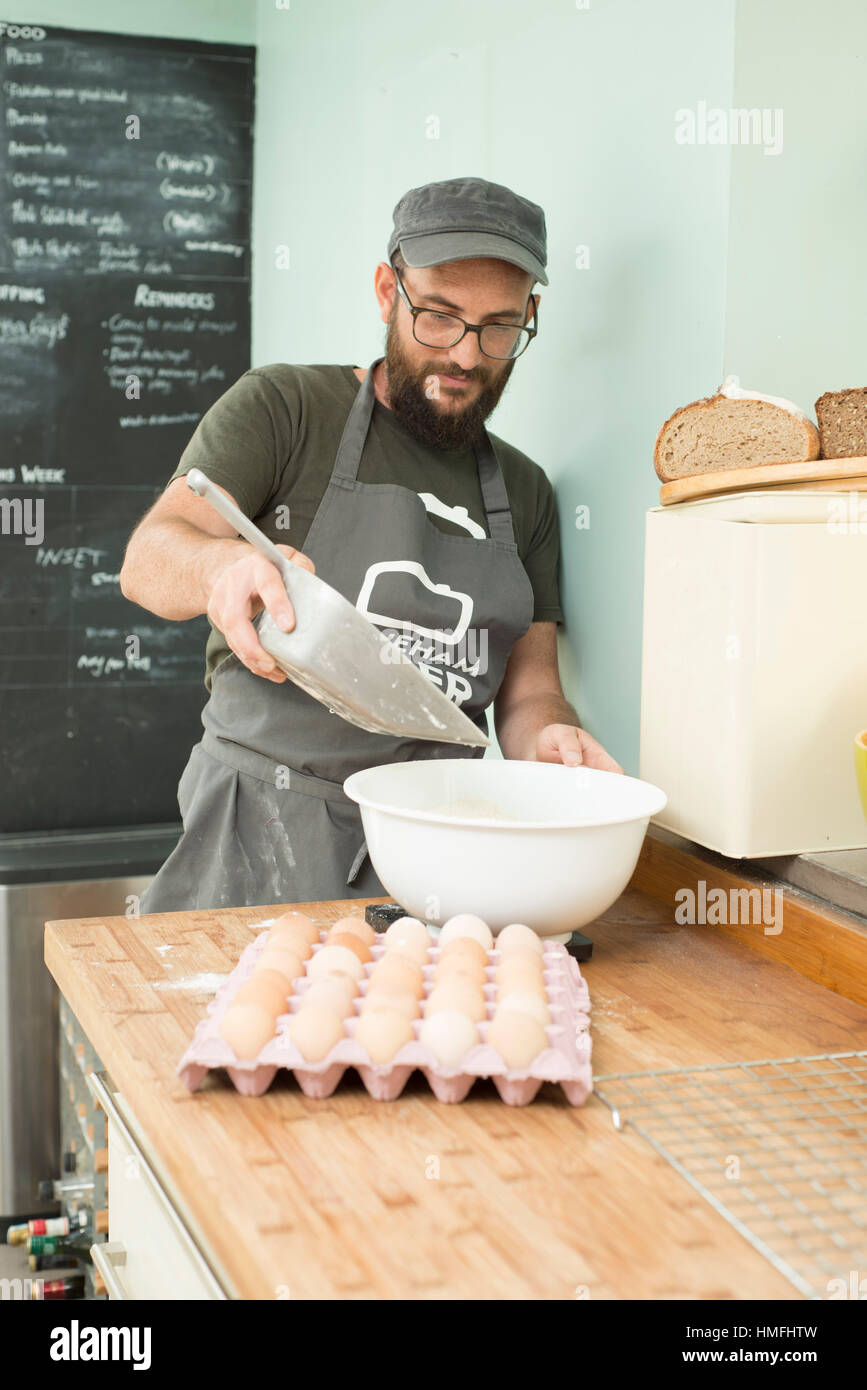 a professional chef prepares and cooks loafs of bread and baking ...
