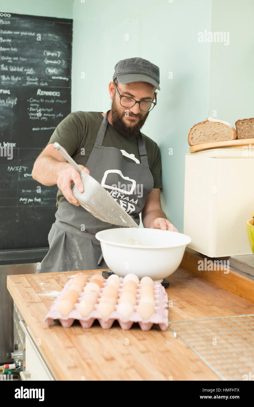 a professional chef prepares and cooks loafs of bread and baking ...