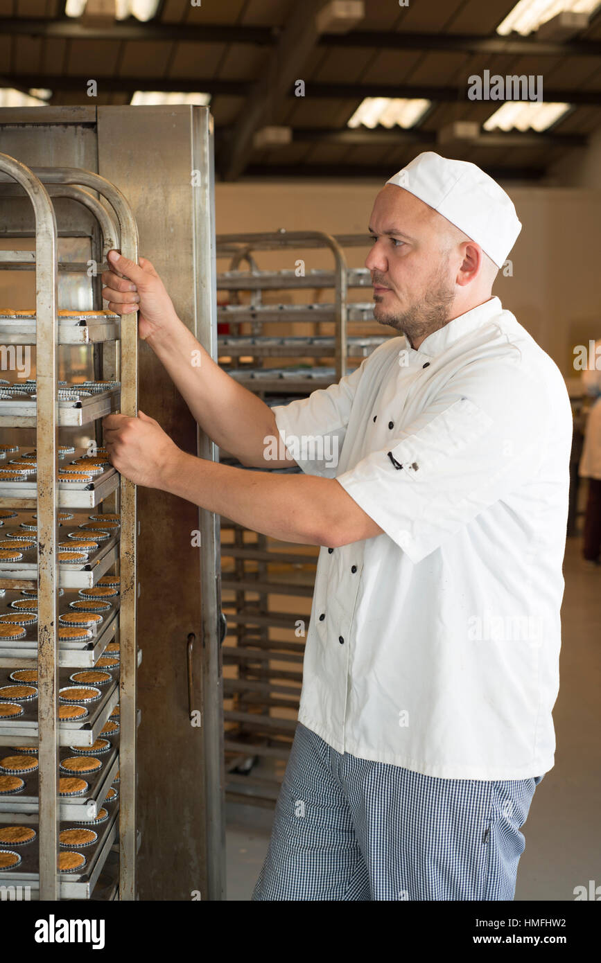a professional chef prepares and cooks loafs of bread and baking ...