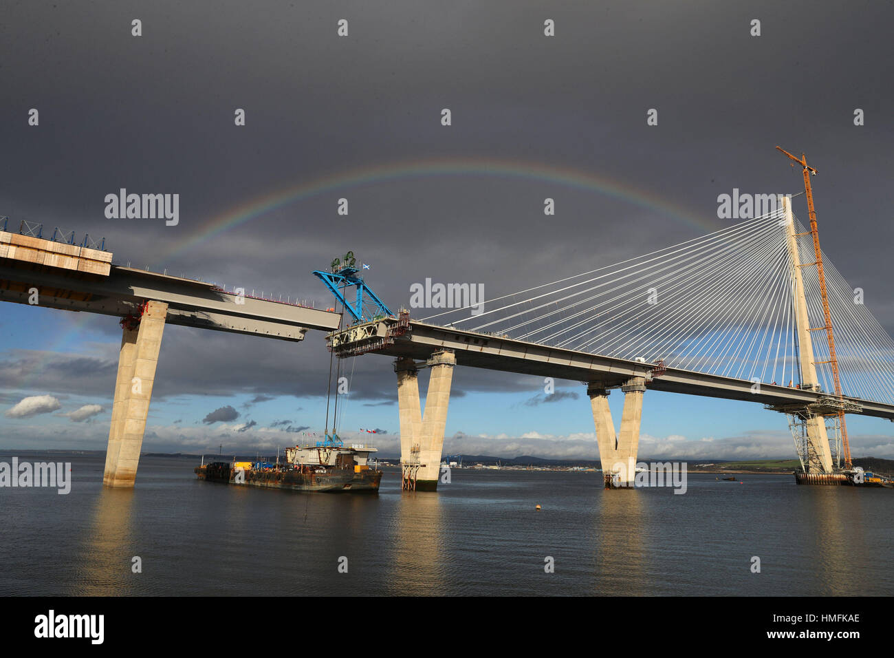 A rainbow is seen as cables are placed on a section of the new ...