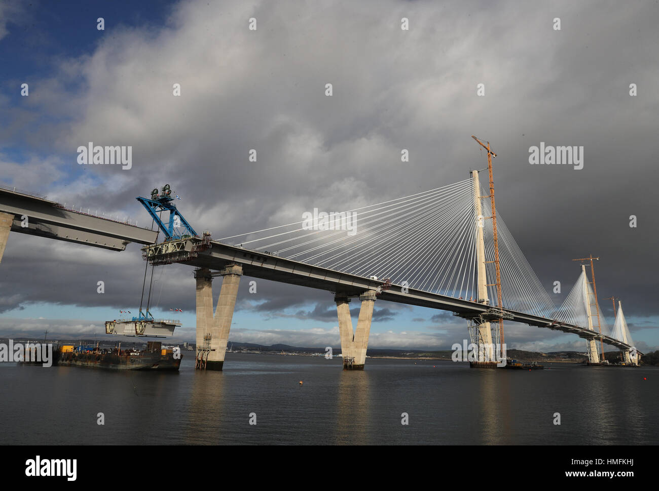 A section of the new Queensferry Crossing bridge is lifted into place ...