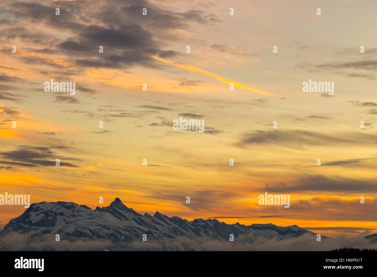 Vibrant orange sunset over snowy mountains in the Alps Stock Photo - Alamy