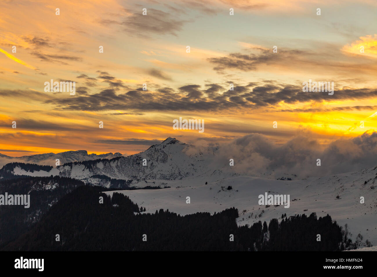 Vibrant orange sunset over snowy mountains in the Alps Stock Photo - Alamy
