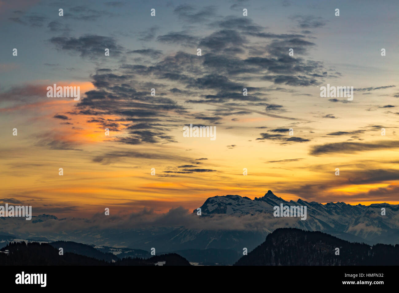 Vibrant orange sunset over snowy mountains in the Alps Stock Photo - Alamy