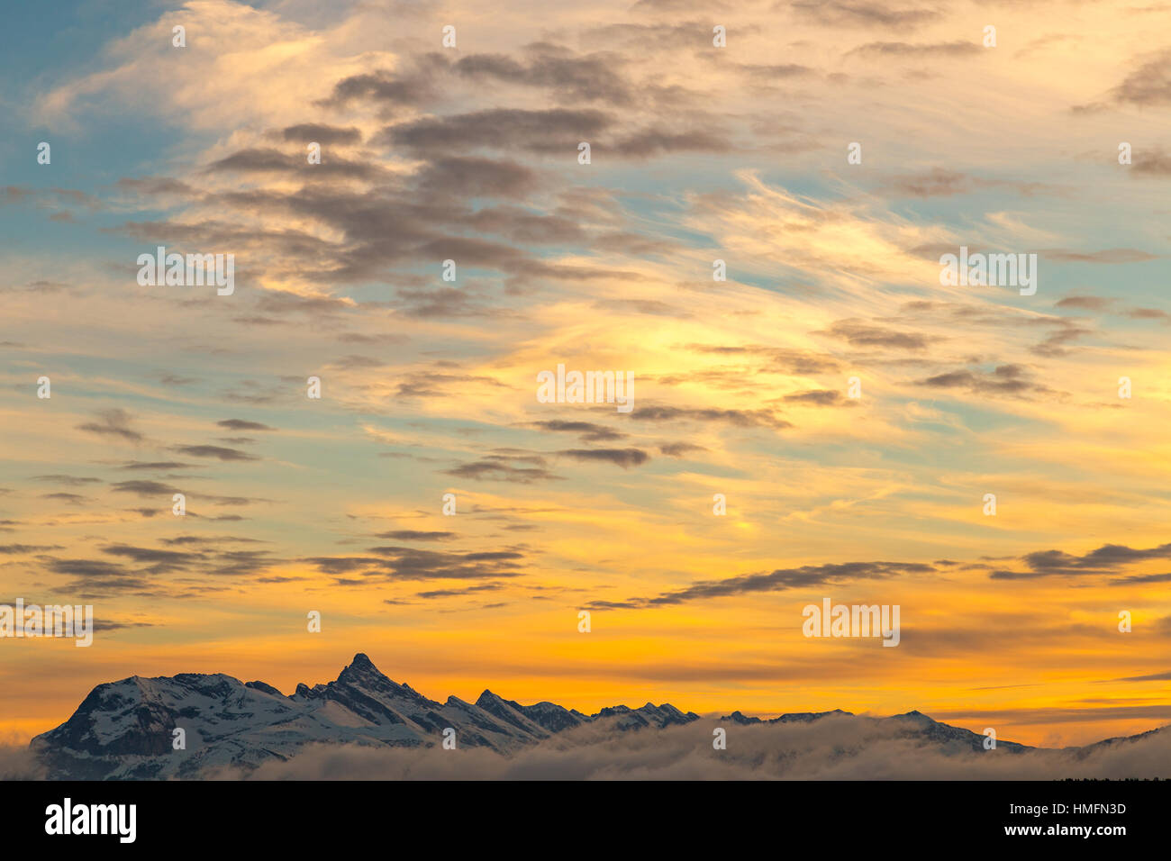 Vibrant orange sunset over snowy mountains in the Alps Stock Photo - Alamy