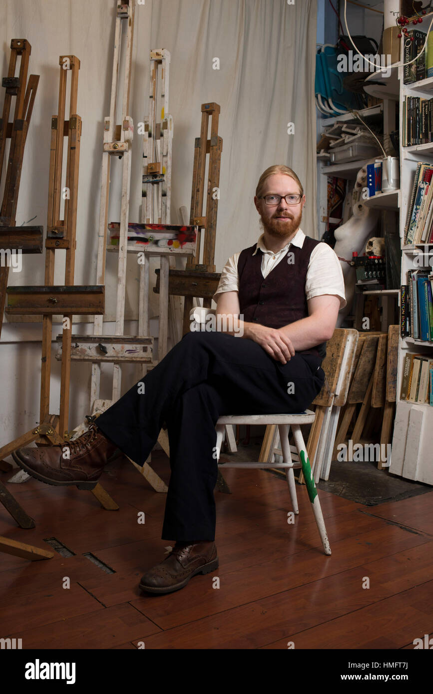 portrait of an artist sitting in their creative art studio shot for a ...