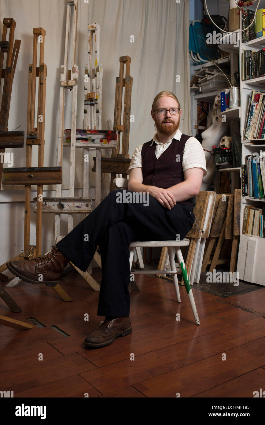 portrait of an artist sitting in their creative art studio shot for a ...