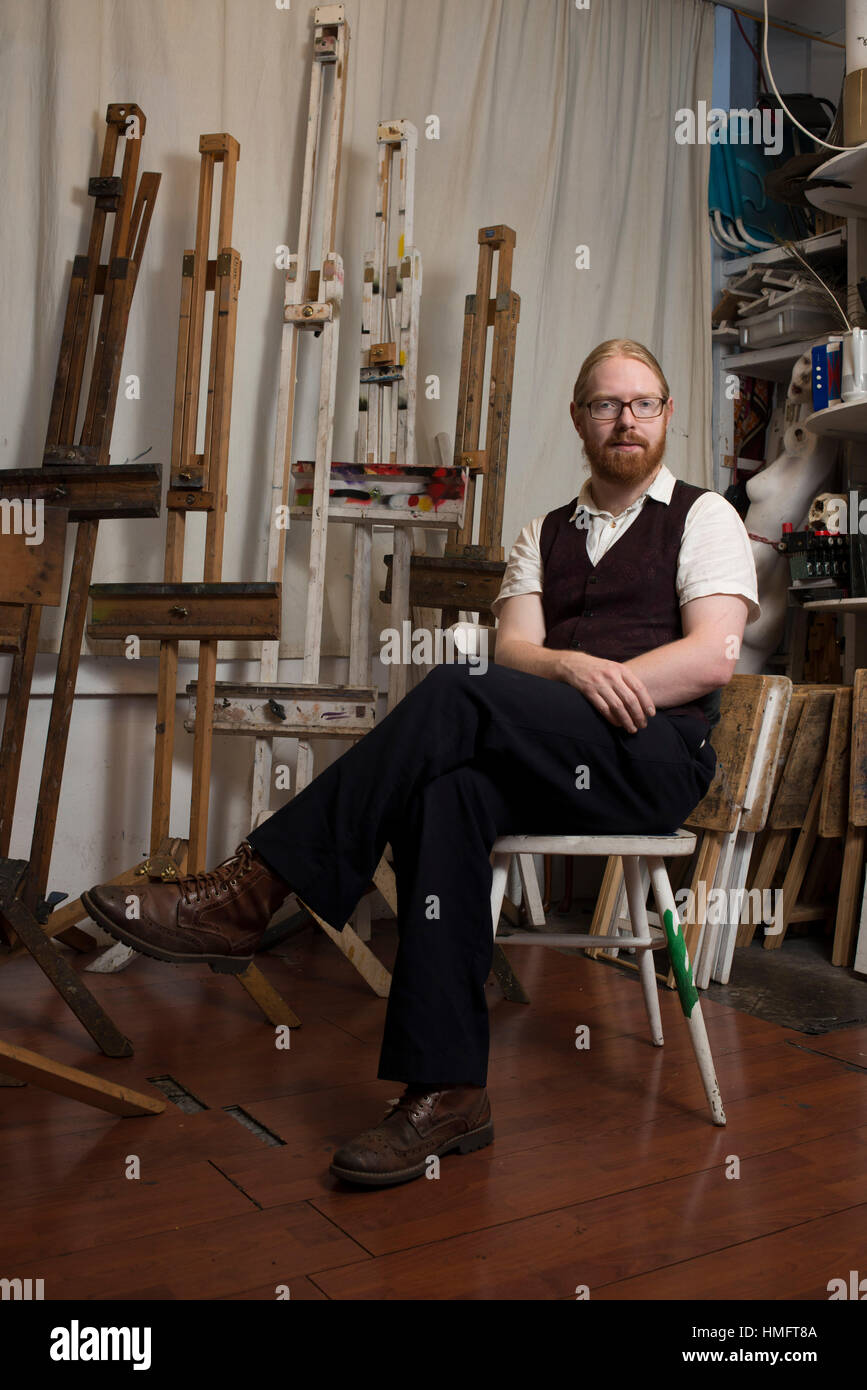 portrait of an artist sitting in their creative art studio shot for a ...