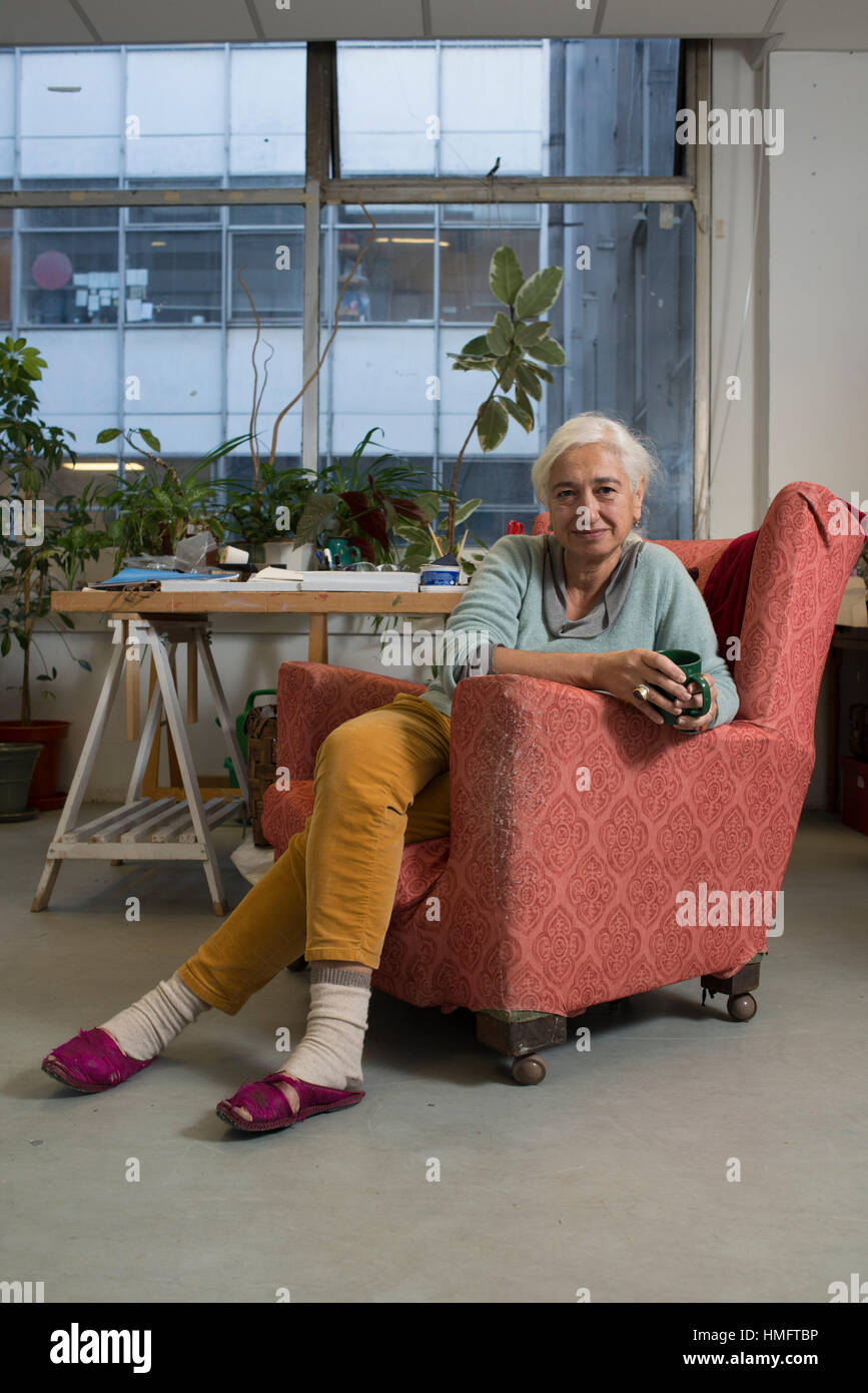 portrait of an artist sitting in their creative art studio shot for a ...