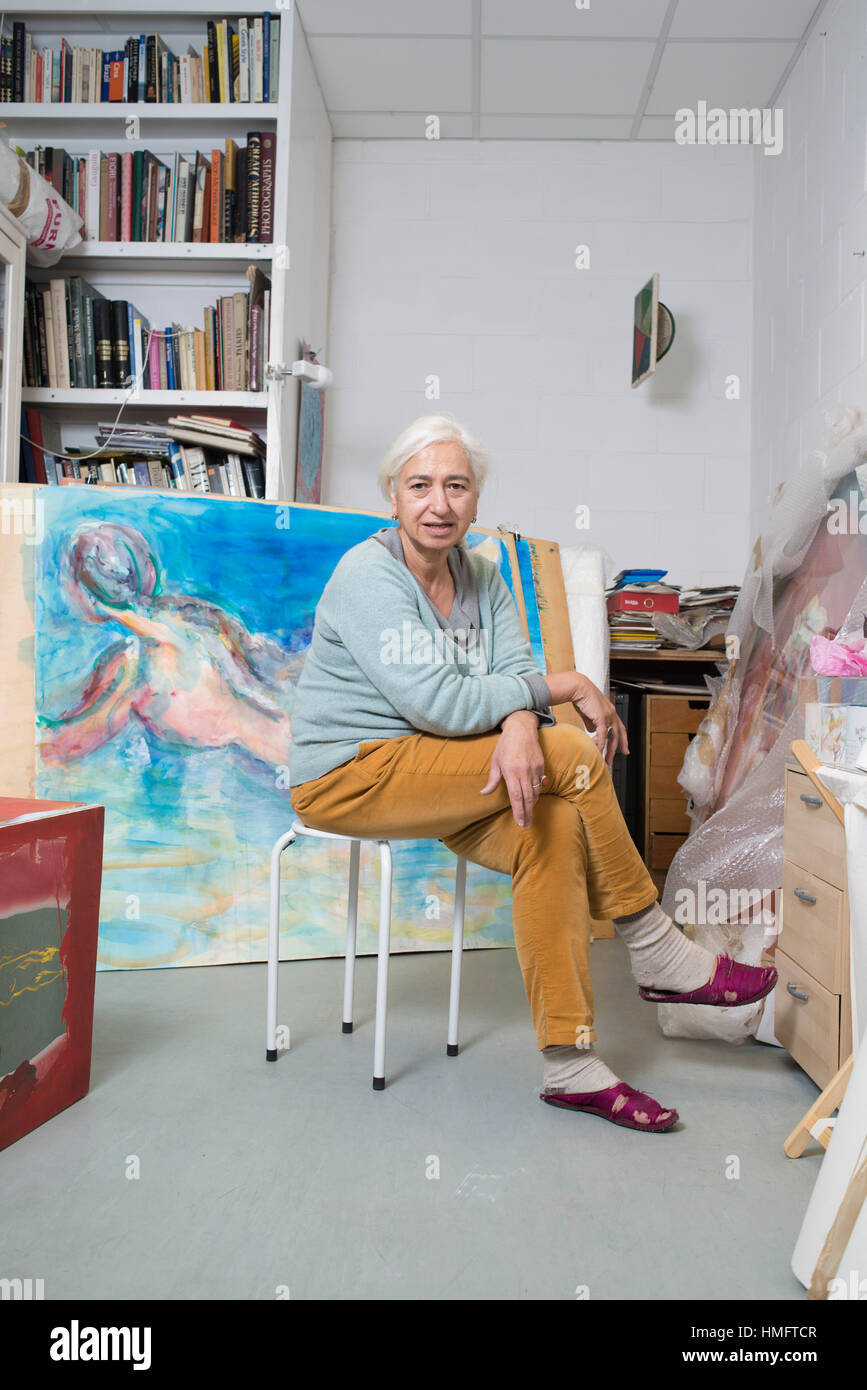 portrait of an artist sitting in their creative art studio shot for a ...