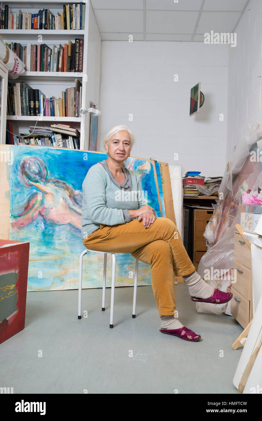 portrait of an artist sitting in their creative art studio shot for a ...