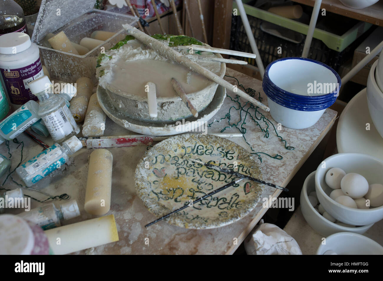 details of an artists studio including easels paints, books, pots ...