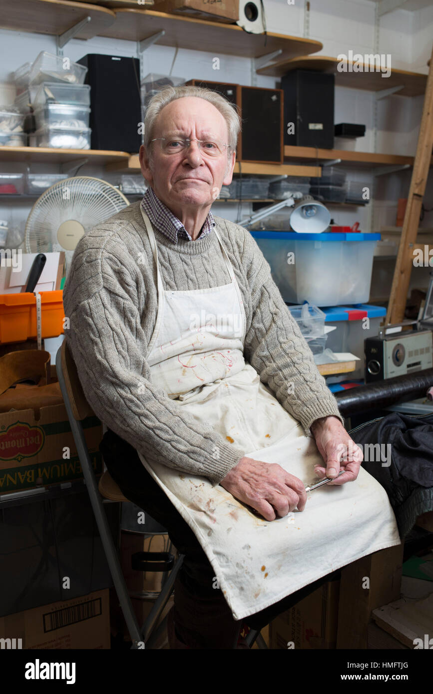 portrait of an artist sitting in their creative art studio shot for a ...