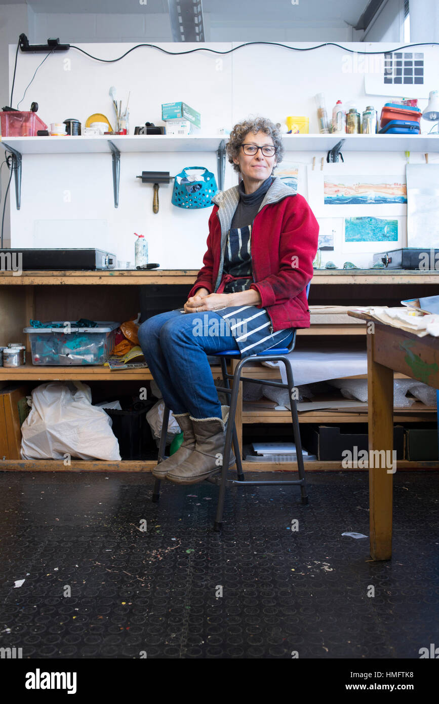 portrait of an artist sitting in their creative art studio shot for a ...