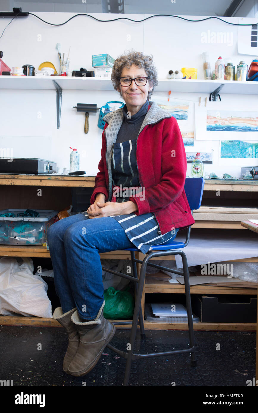 portrait of an artist sitting in their creative art studio shot for a ...
