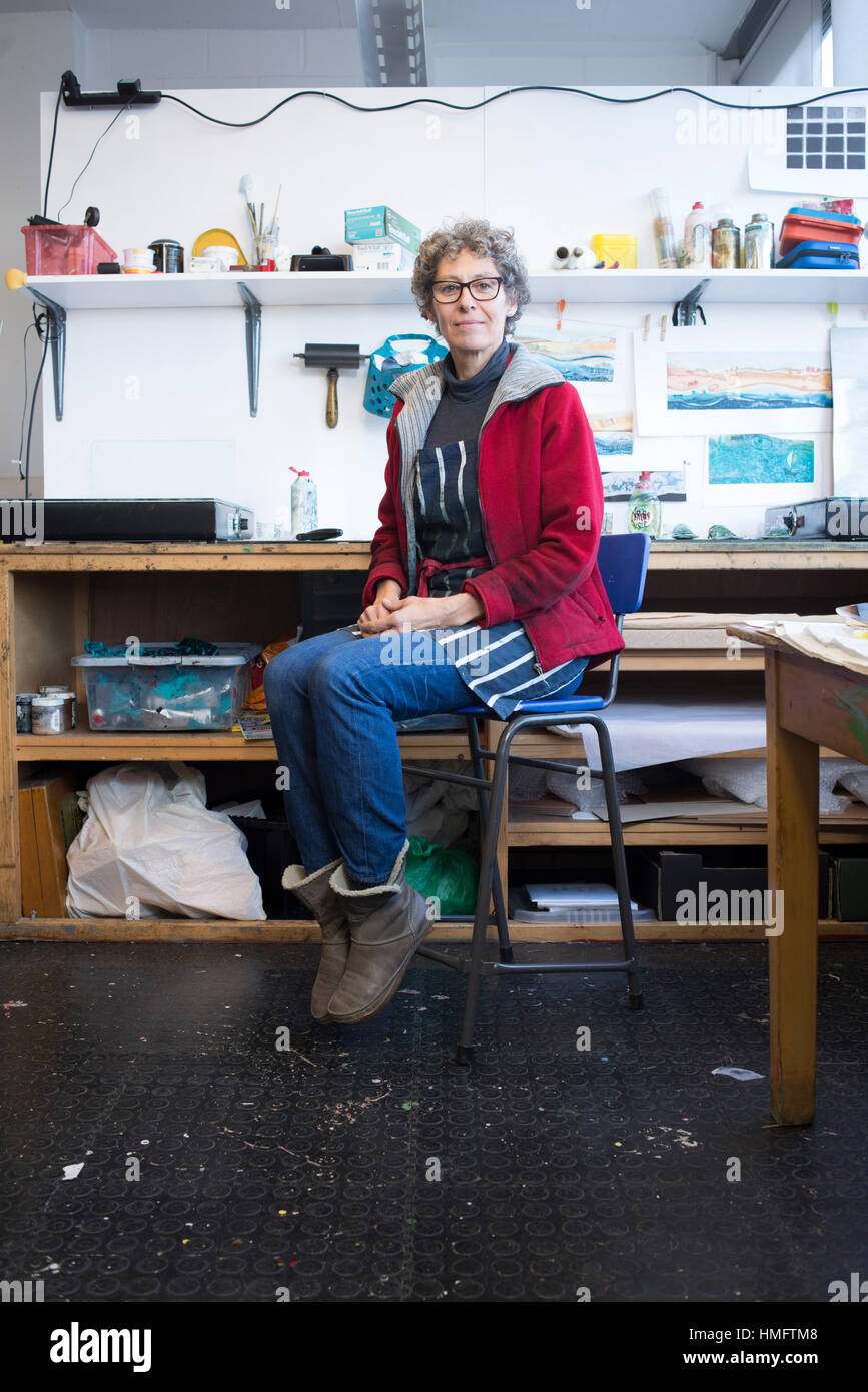 portrait of an artist sitting in their creative art studio shot for a ...