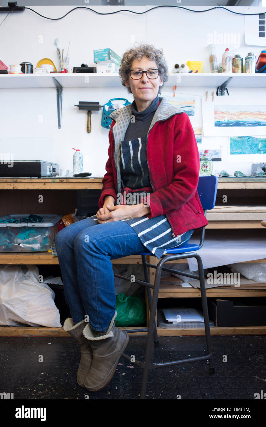 portrait of an artist sitting in their creative art studio shot for a ...