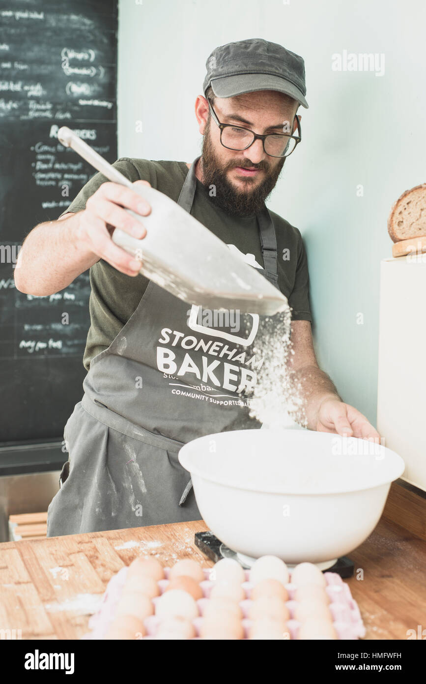 a professional chef prepares and cooks loafs of bread and baking ...