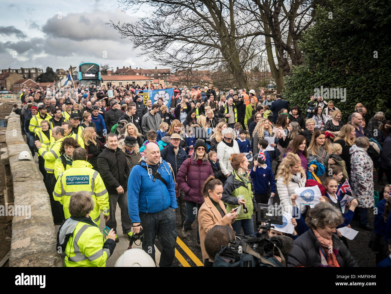 Members of the public stand on Tadcaster Bridge as it reopens more than ...