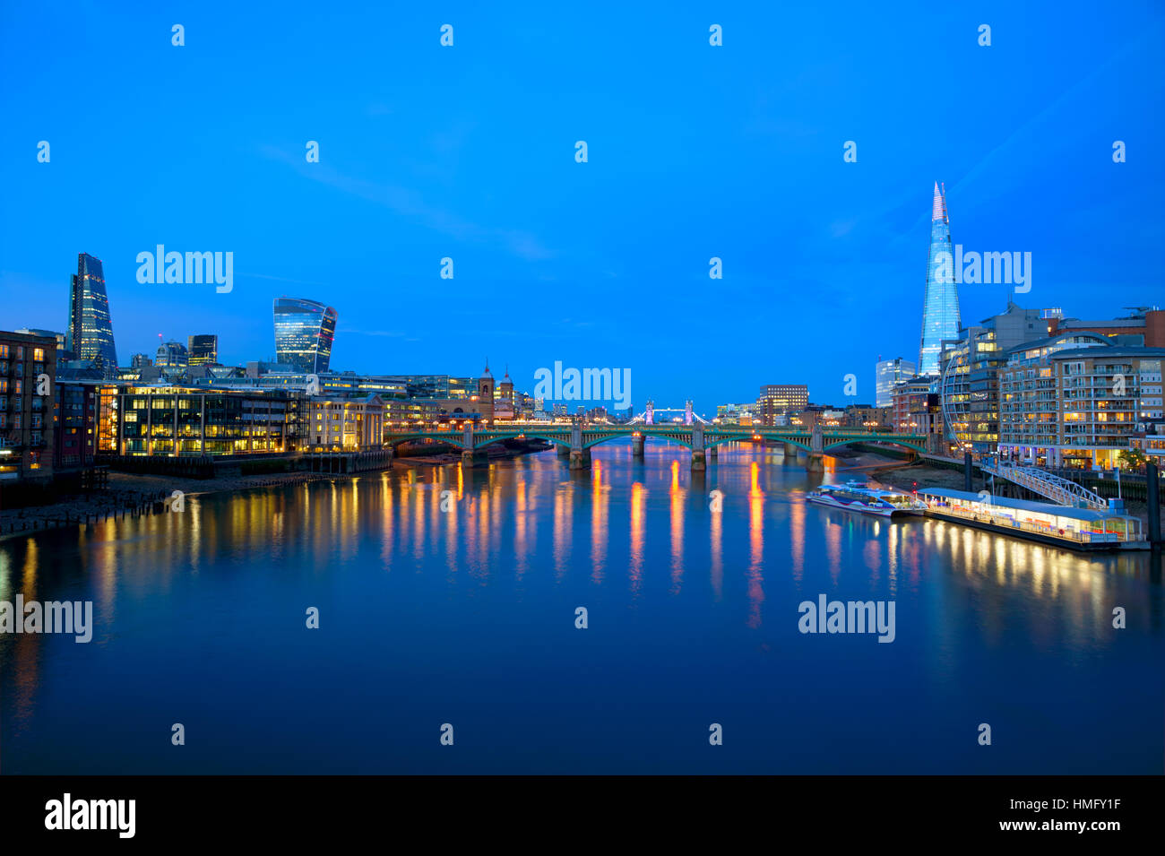 London skyline sunset on Thames river reflection at UK Stock Photo - Alamy