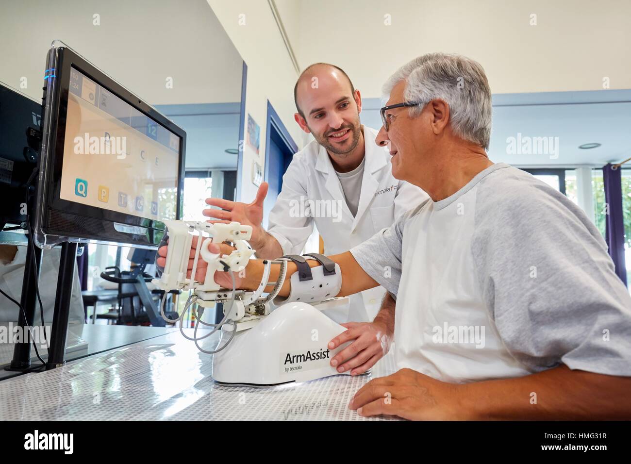 Therapist and patient with assistive robot for upper limb ...