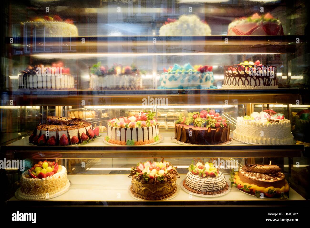 Display of cakes topped with fruits in a Chinese pastry shop. London ...