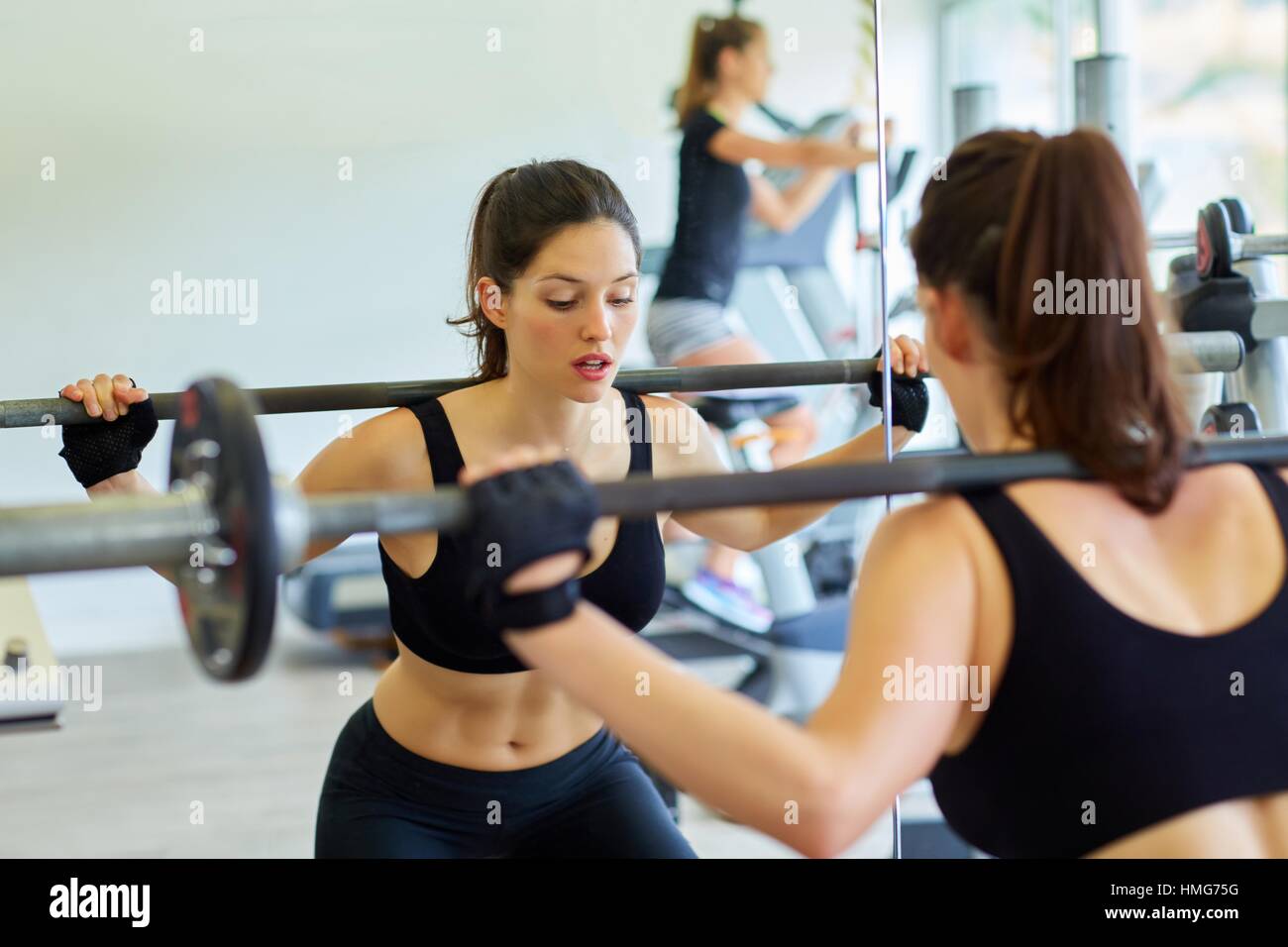 Dumbbells, Woman lifting weights at the gym Stock Photo - Alamy