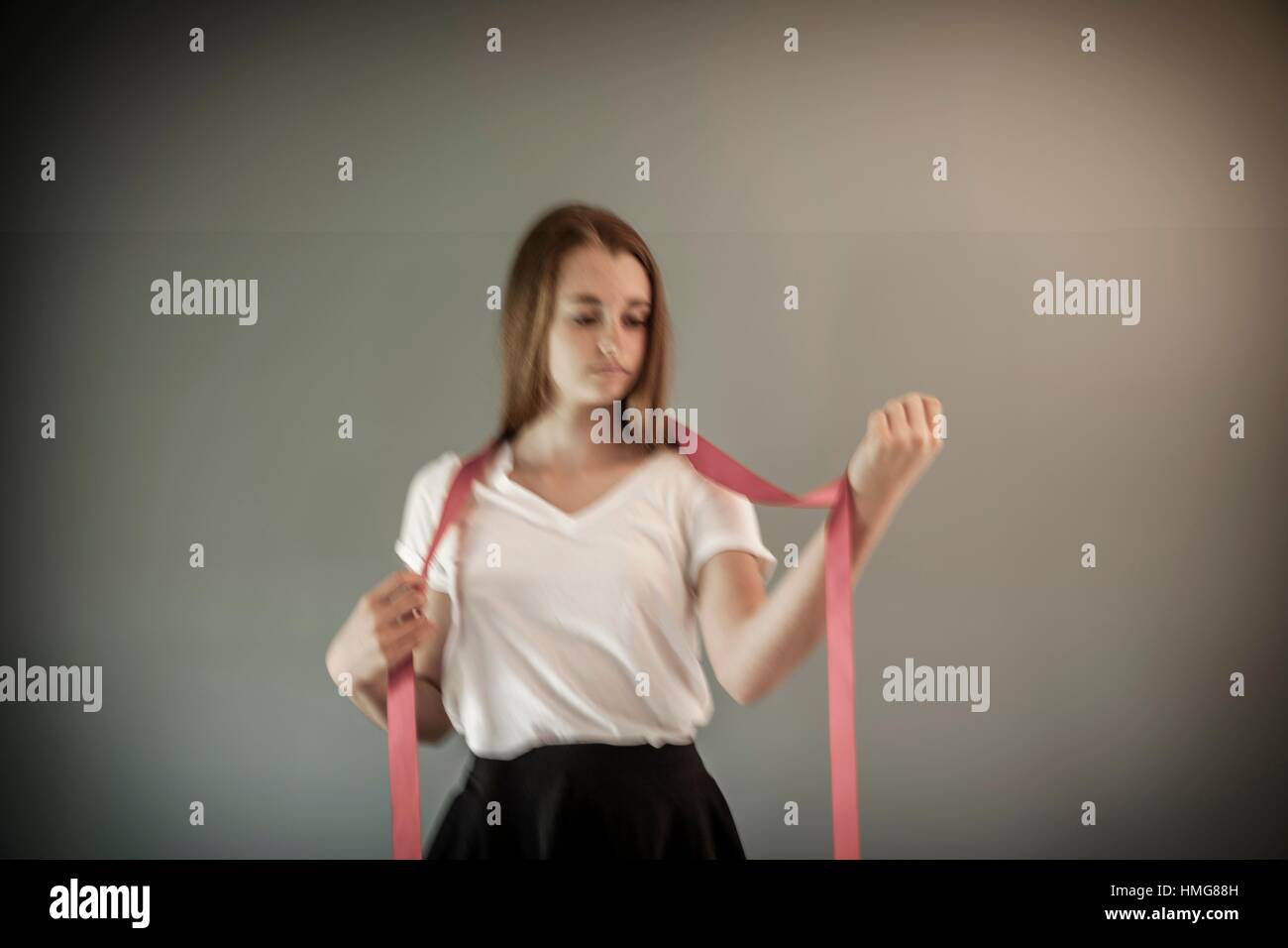 Teenage girl holding a red ribbon Stock Photo - Alamy