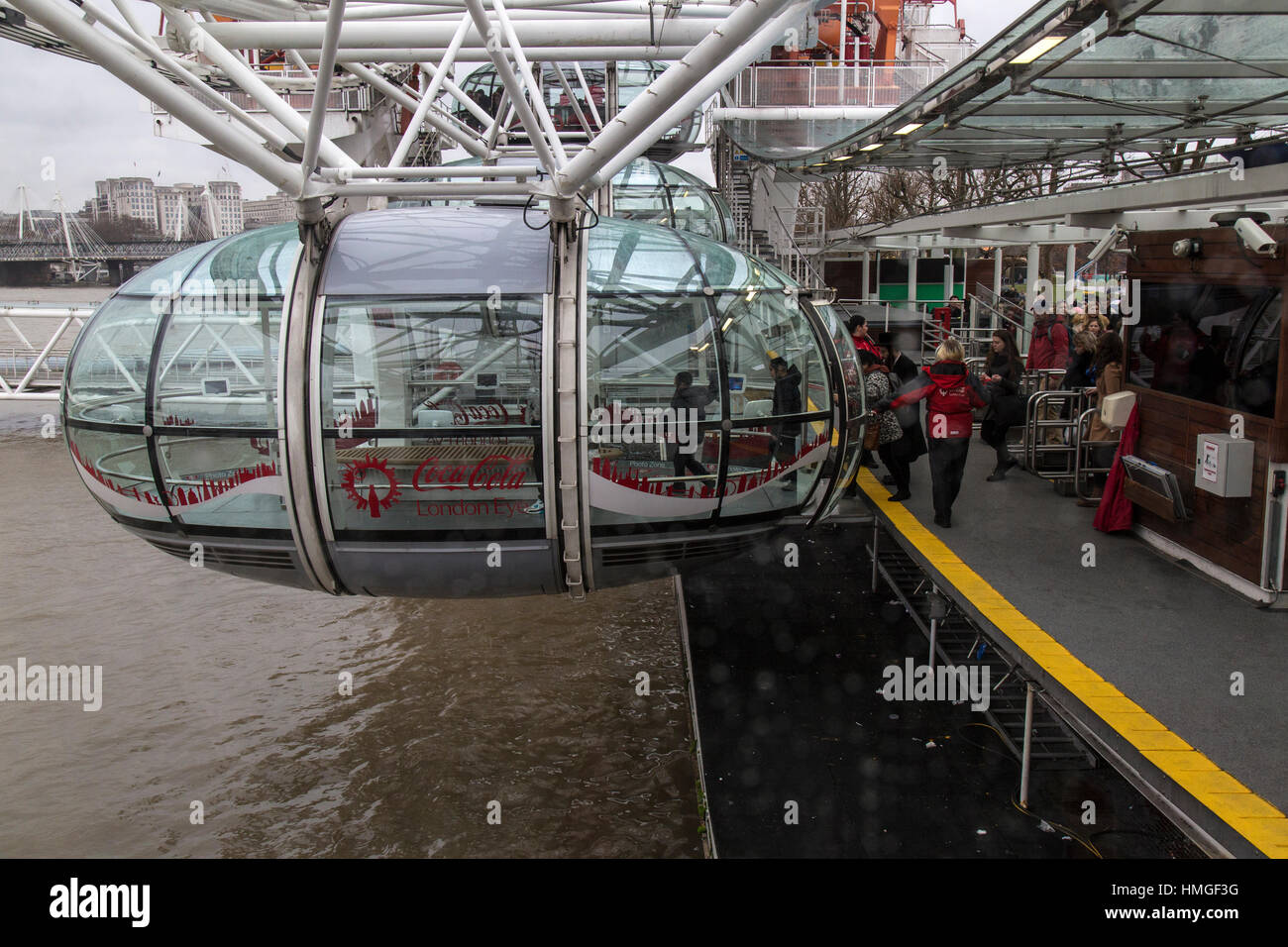Tourists entering a capsule on the London Eye ferris wheel Stock Photo ...